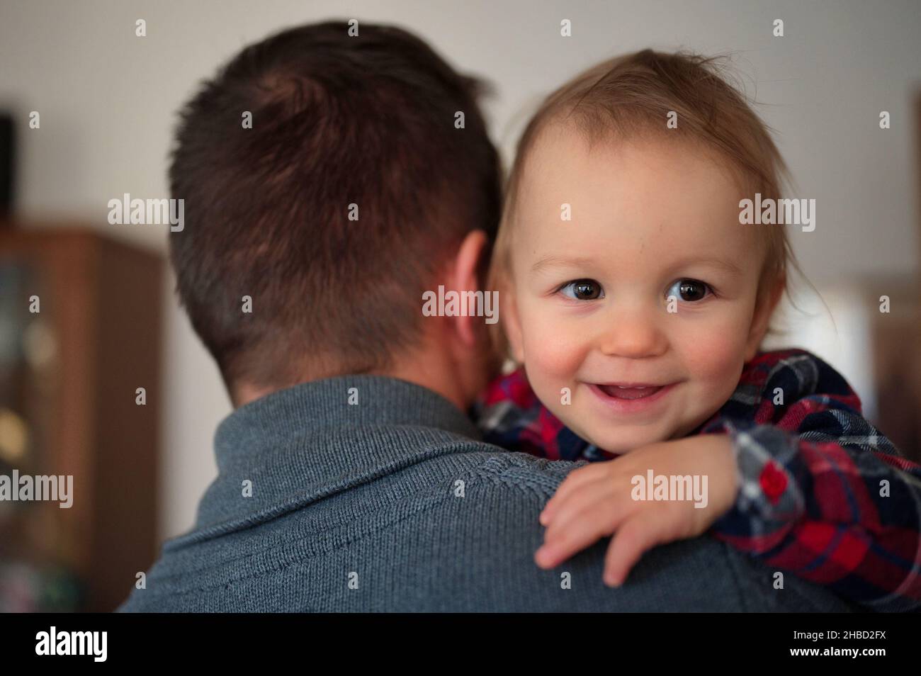 Portrait of cute little boy in his father arms Stock Photo - Alamy