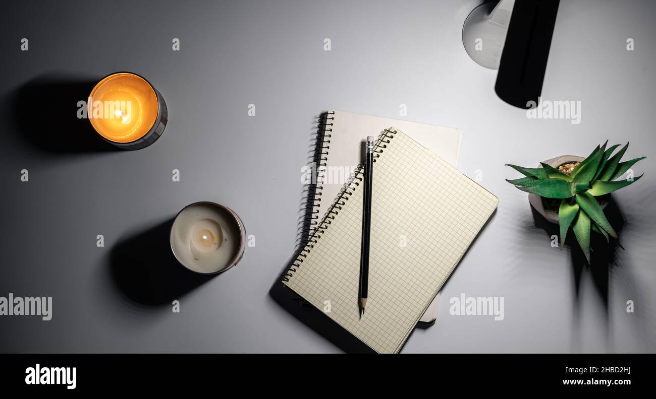 Flat lay, notepad and lamp, workplace at night Stock Photo - Alamy
