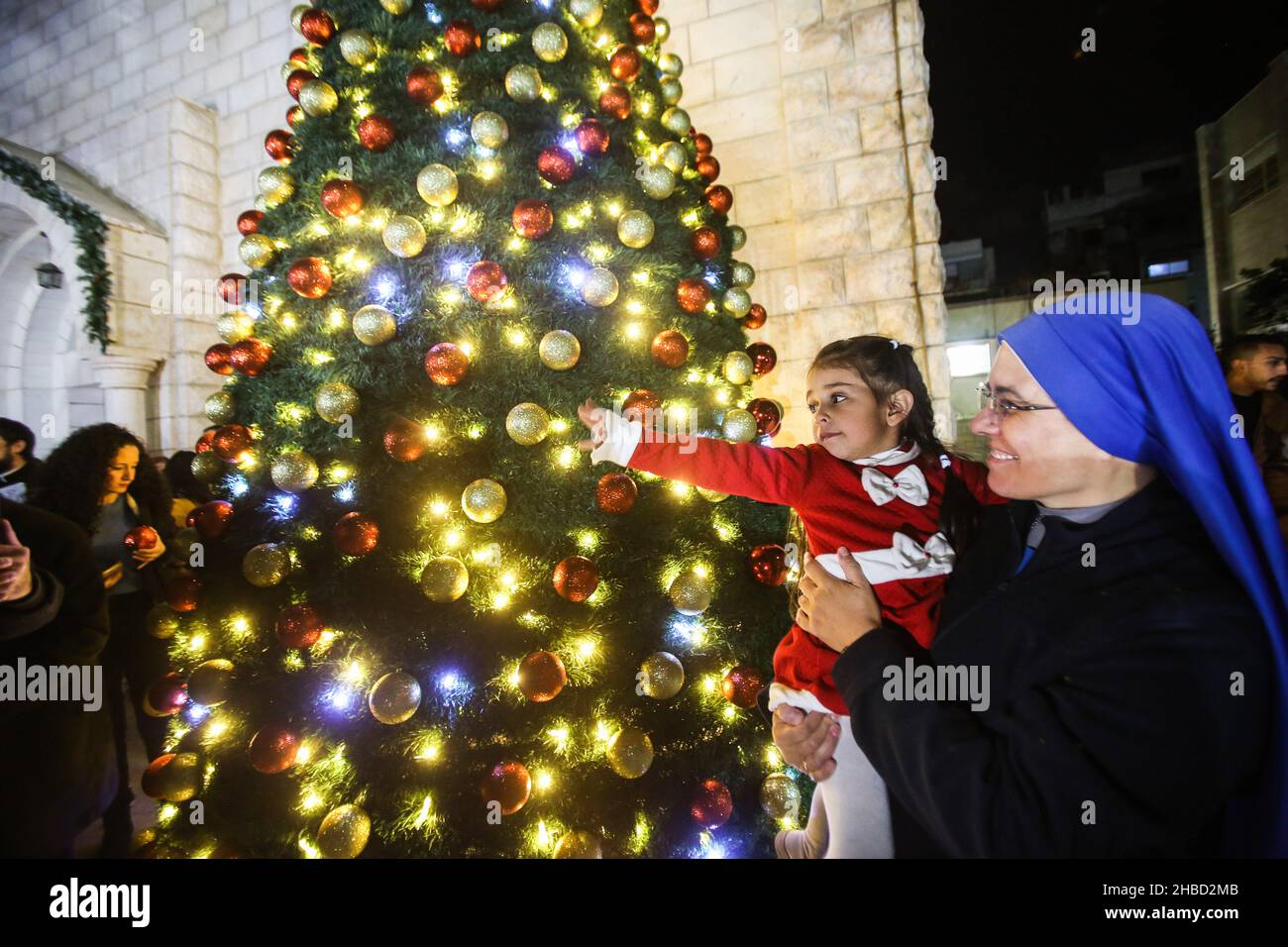 A nun seen carrying a baby and they are celebrating near the lighting ...