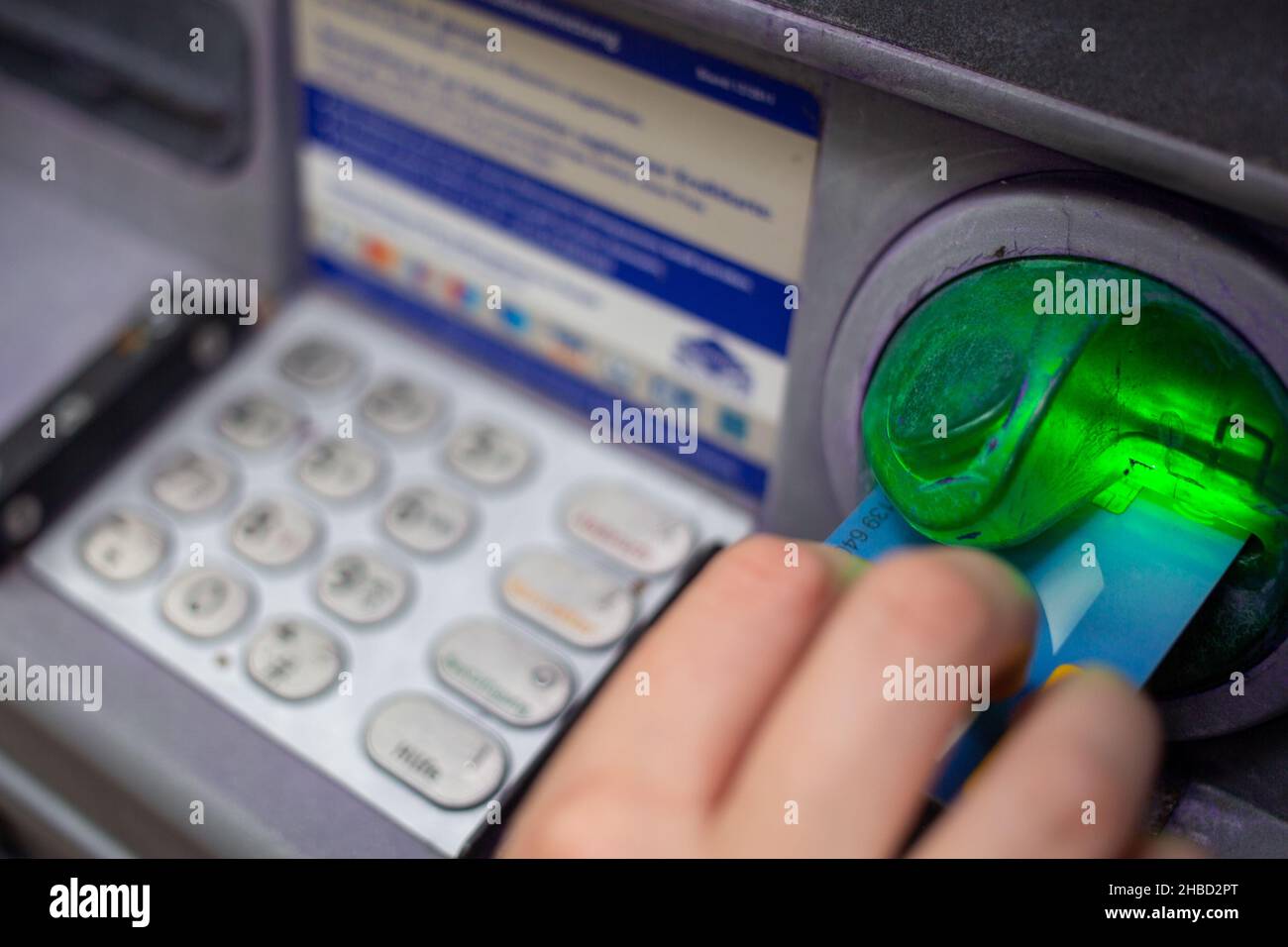 Berlin, Germany. 29th Aug, 2021. A bank customer inserts her giro card ...
