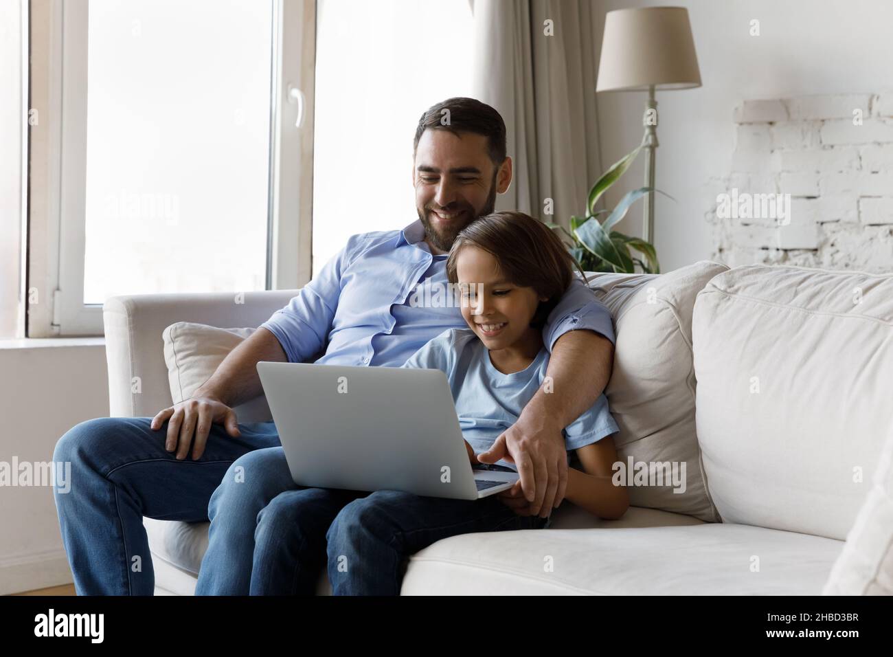 Happy young father and small son using computer Stock Photo - Alamy