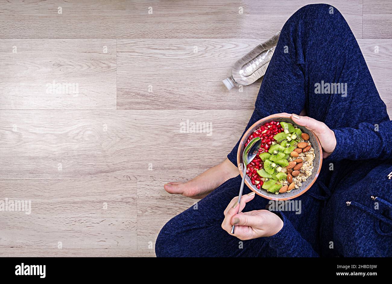 Fitness and healthy lifestyle concept. Female is resting and eating a ...