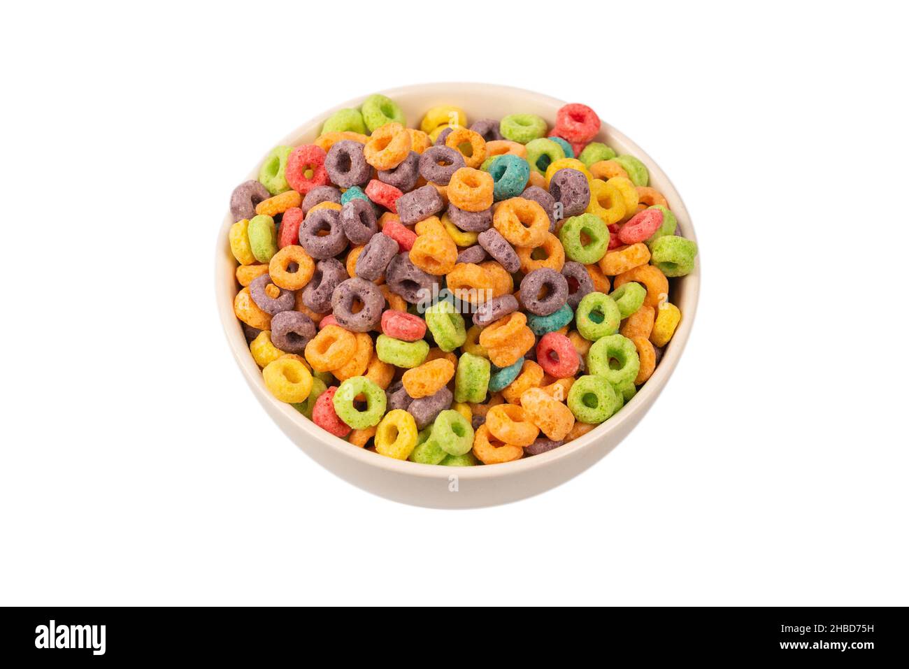 Colorful rings cereal spill out into a bowl. Breakfast. Isolated on a ...