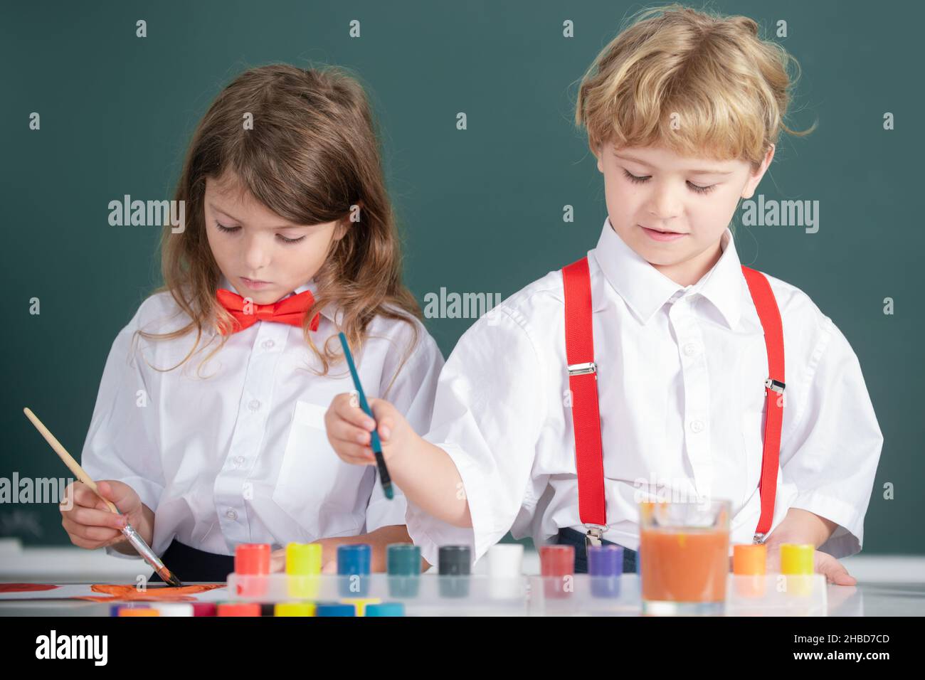 Funny pupils draws in classroom on school blackboard background. School ...