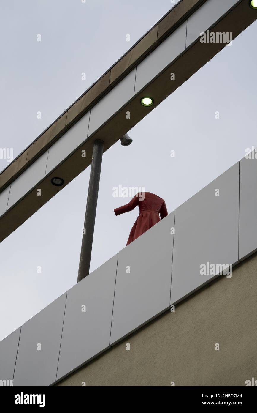A low angle view of a female dress on the edge of a modern building ...