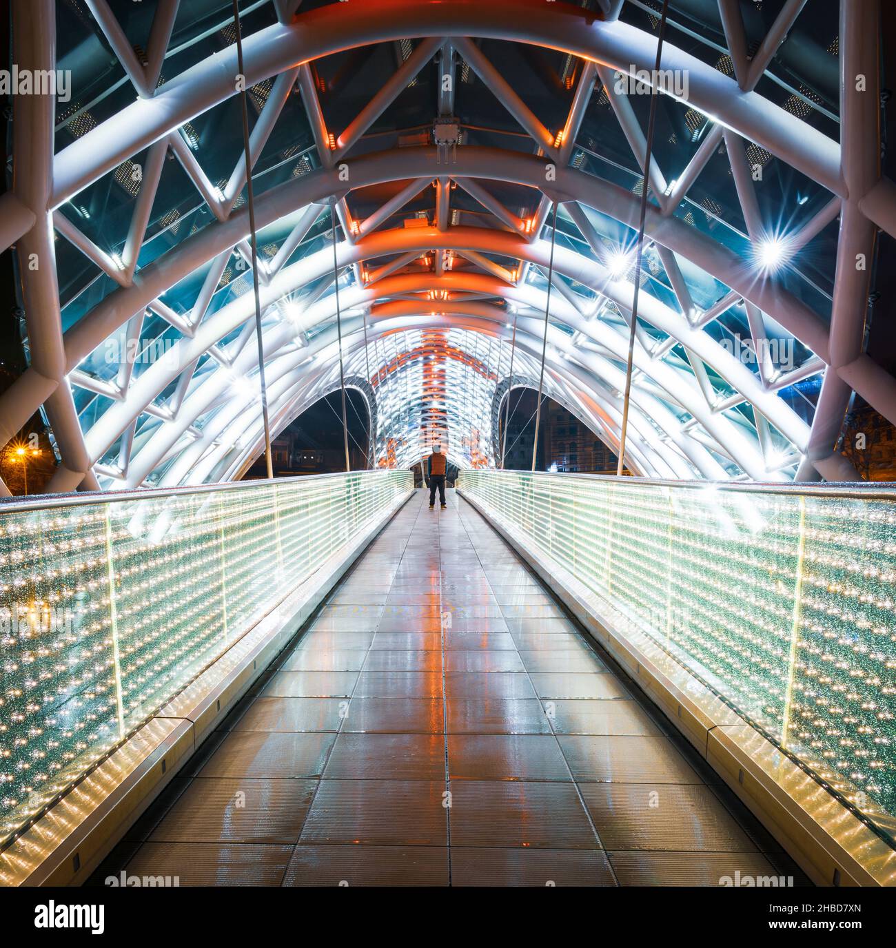 Background nightscape image of tourist walkway and tourist standing on ...