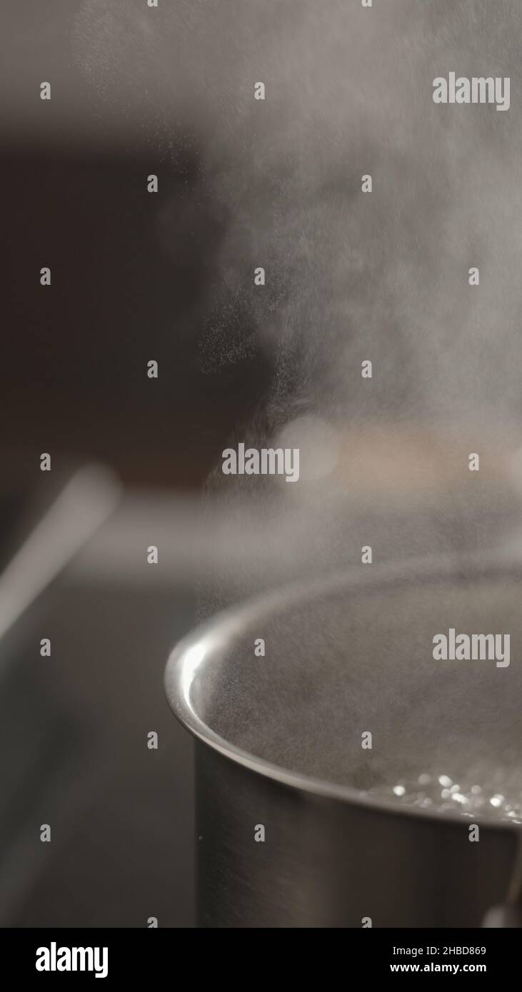 vertical shot pasta boiling in saucepan on induction stove, vertical ...