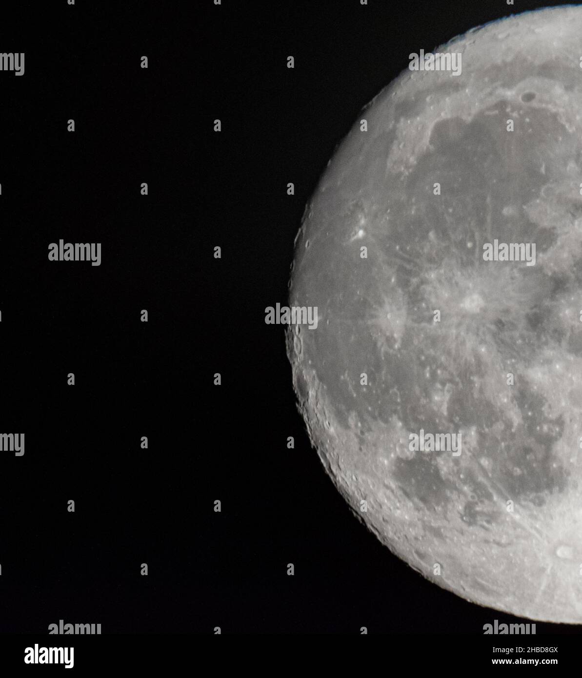 Croped full moon on the black background seen through telescope with ...