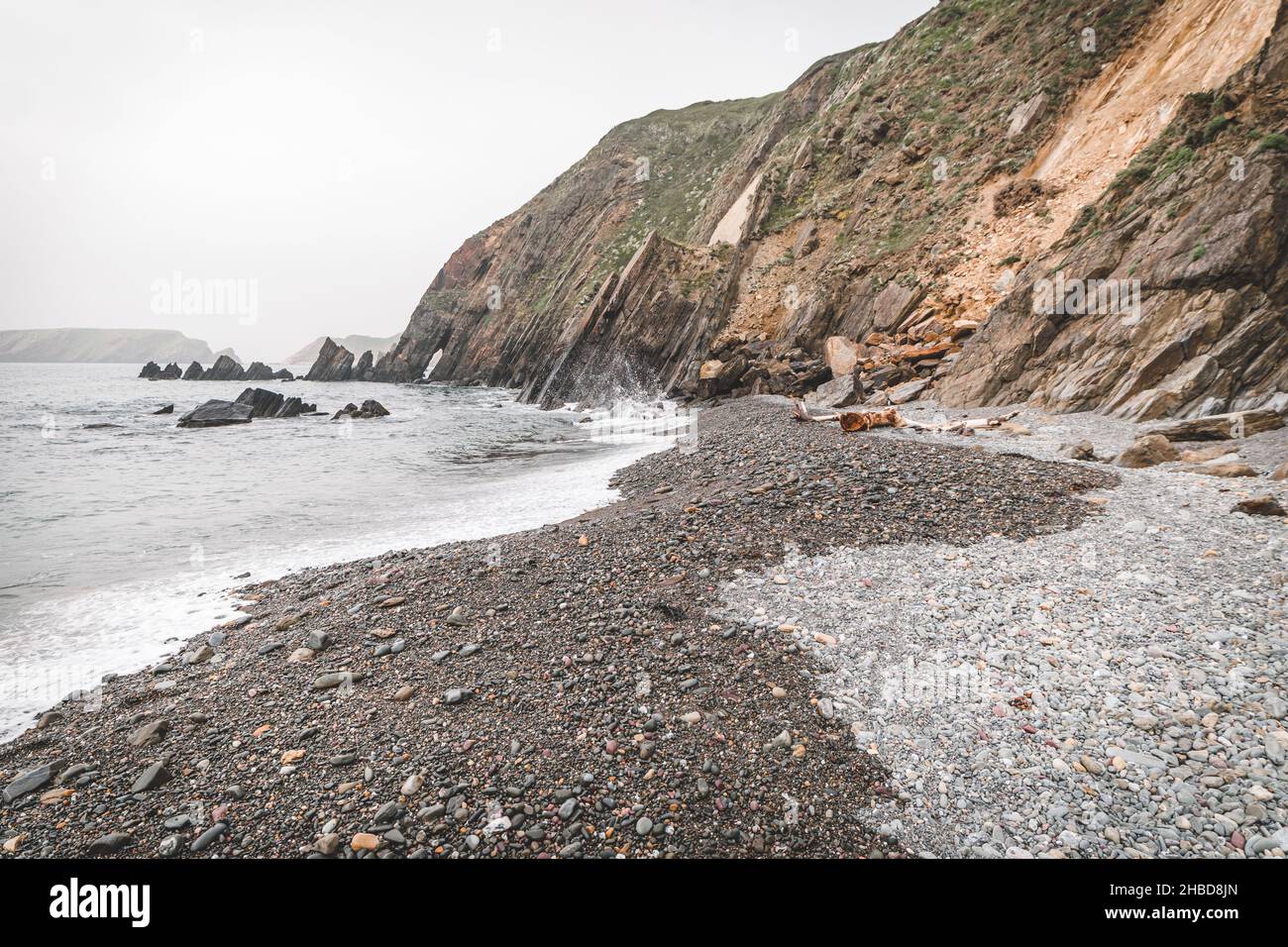 rocky beach with cliffs and calm shore during the low tide and no ...