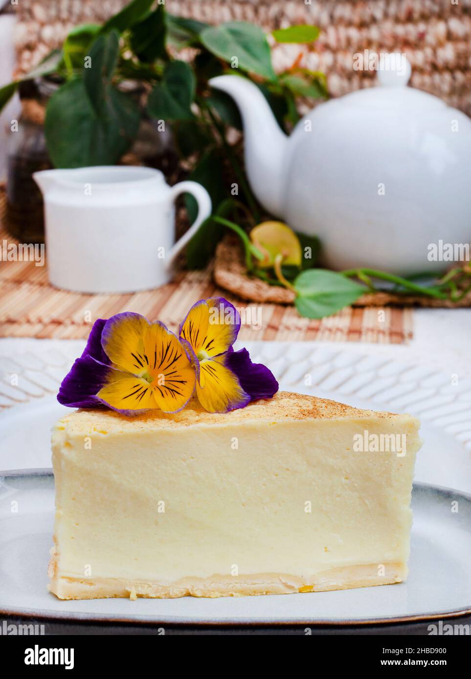 Cheesecake slice with edible flowers and selective focus Stock Photo ...