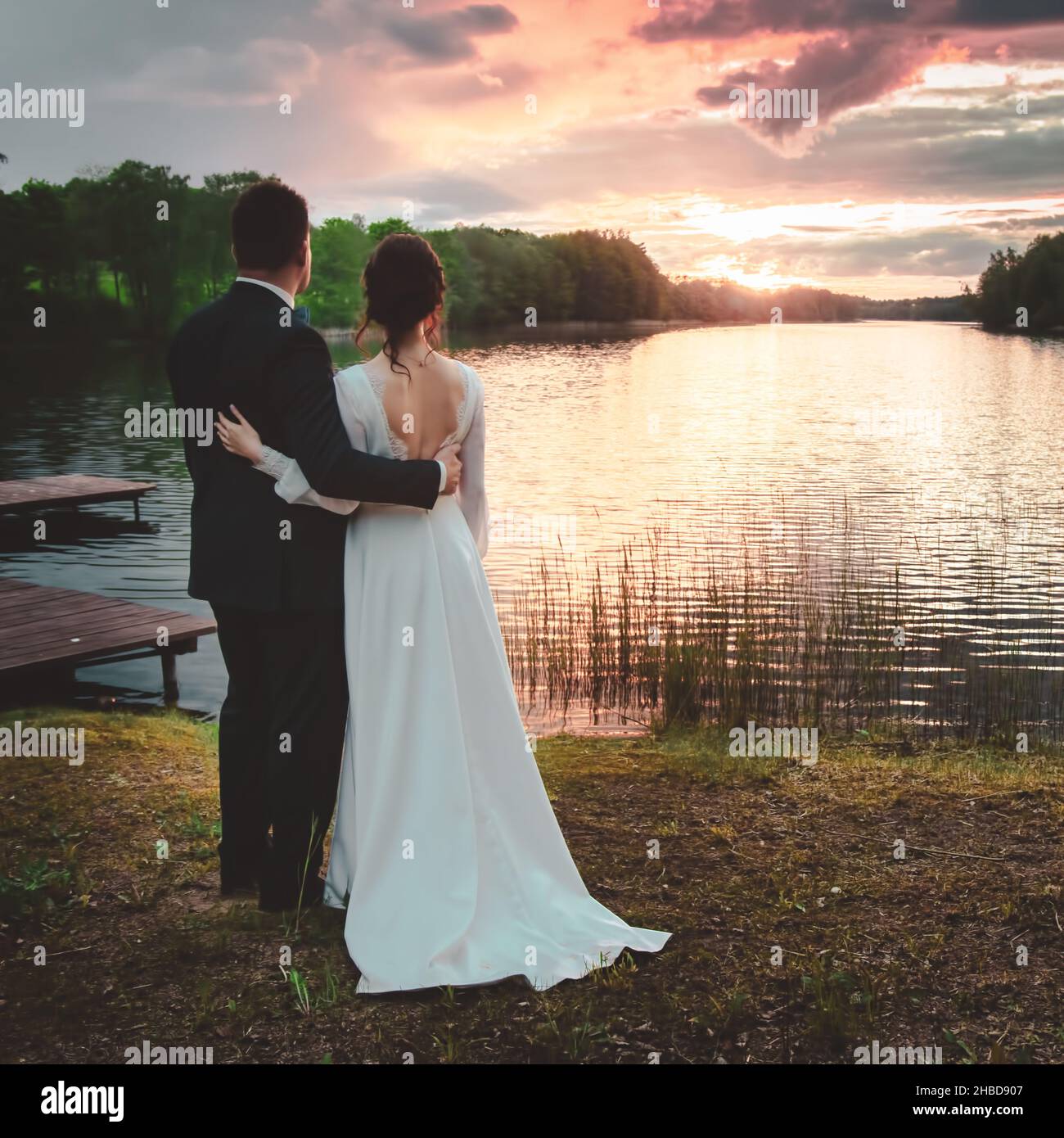 Back view caucasian wedding couple stand together on viewpoint enjoy ...