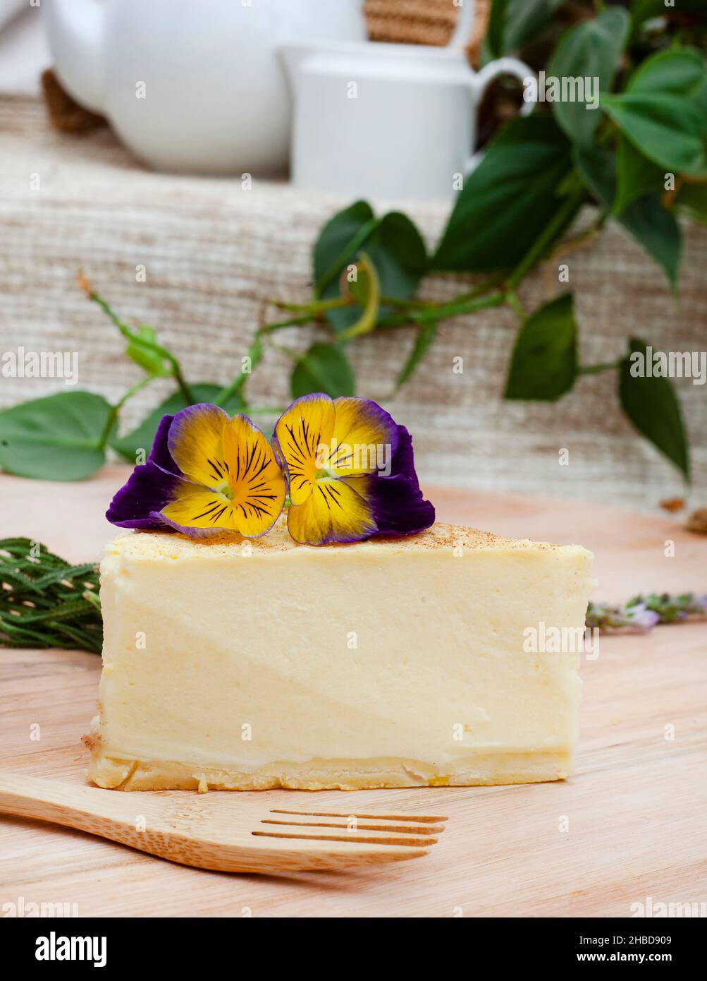Cheesecake slice with edible flowers and selective focus Stock Photo ...