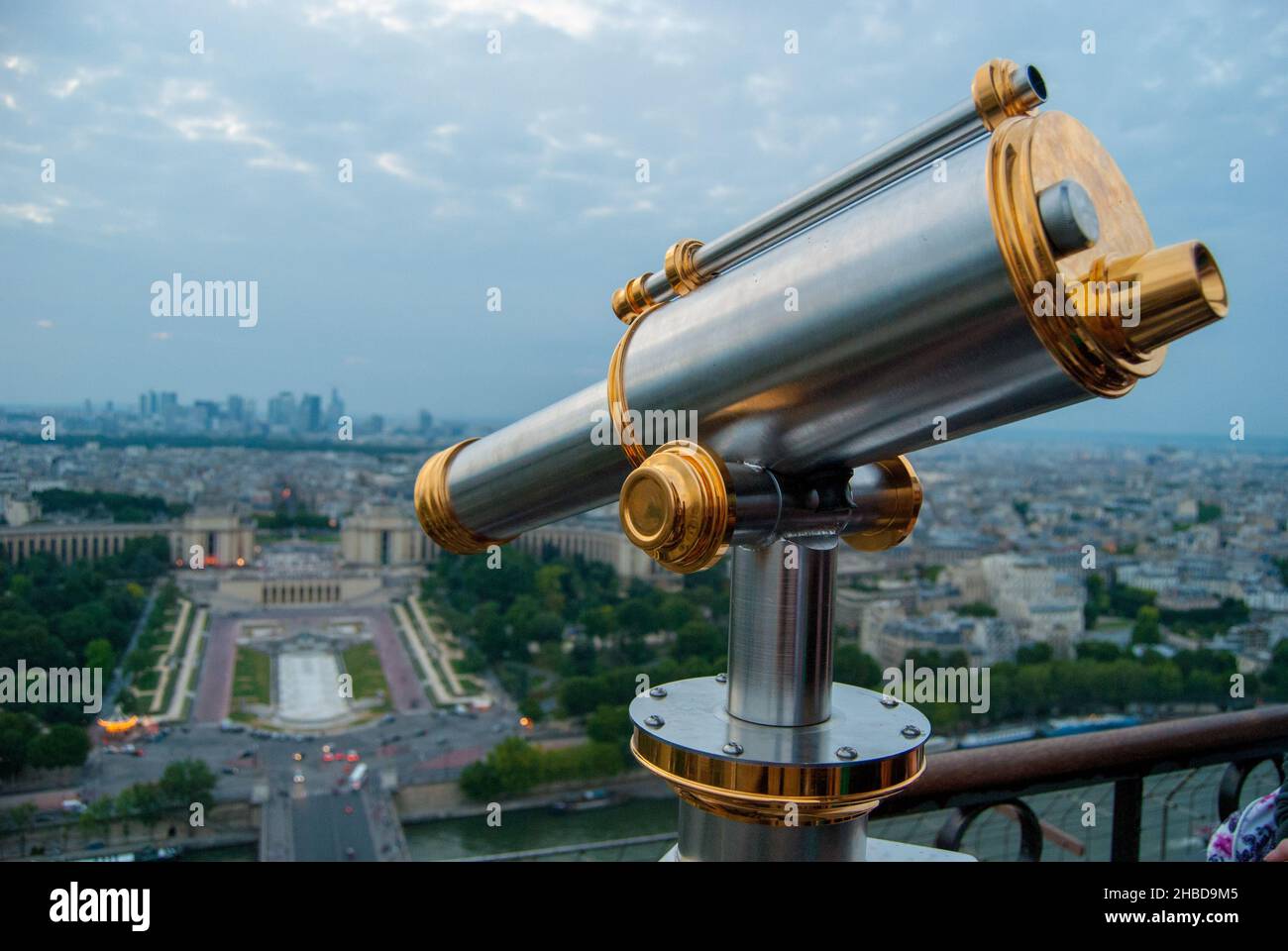 A silver vintage Coin Operated Telescope on top of a metal tower and a ...