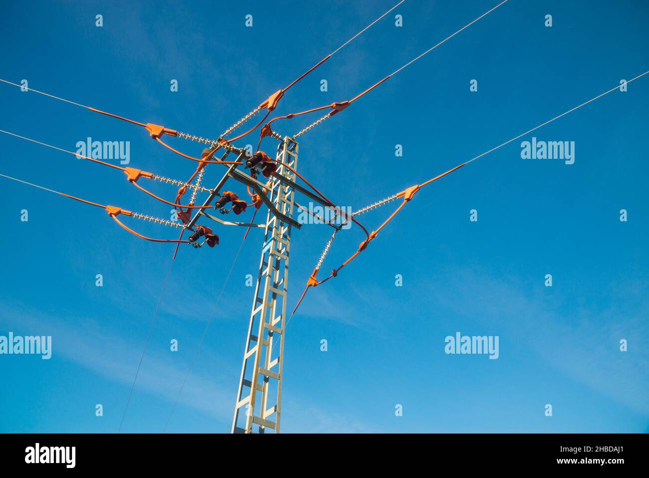 High voltage pylon against blue sky Stock Photo - Alamy