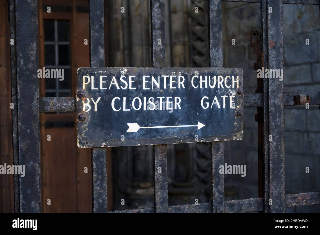 Enter church by cloister gate entrance sign Stock Photo - Alamy