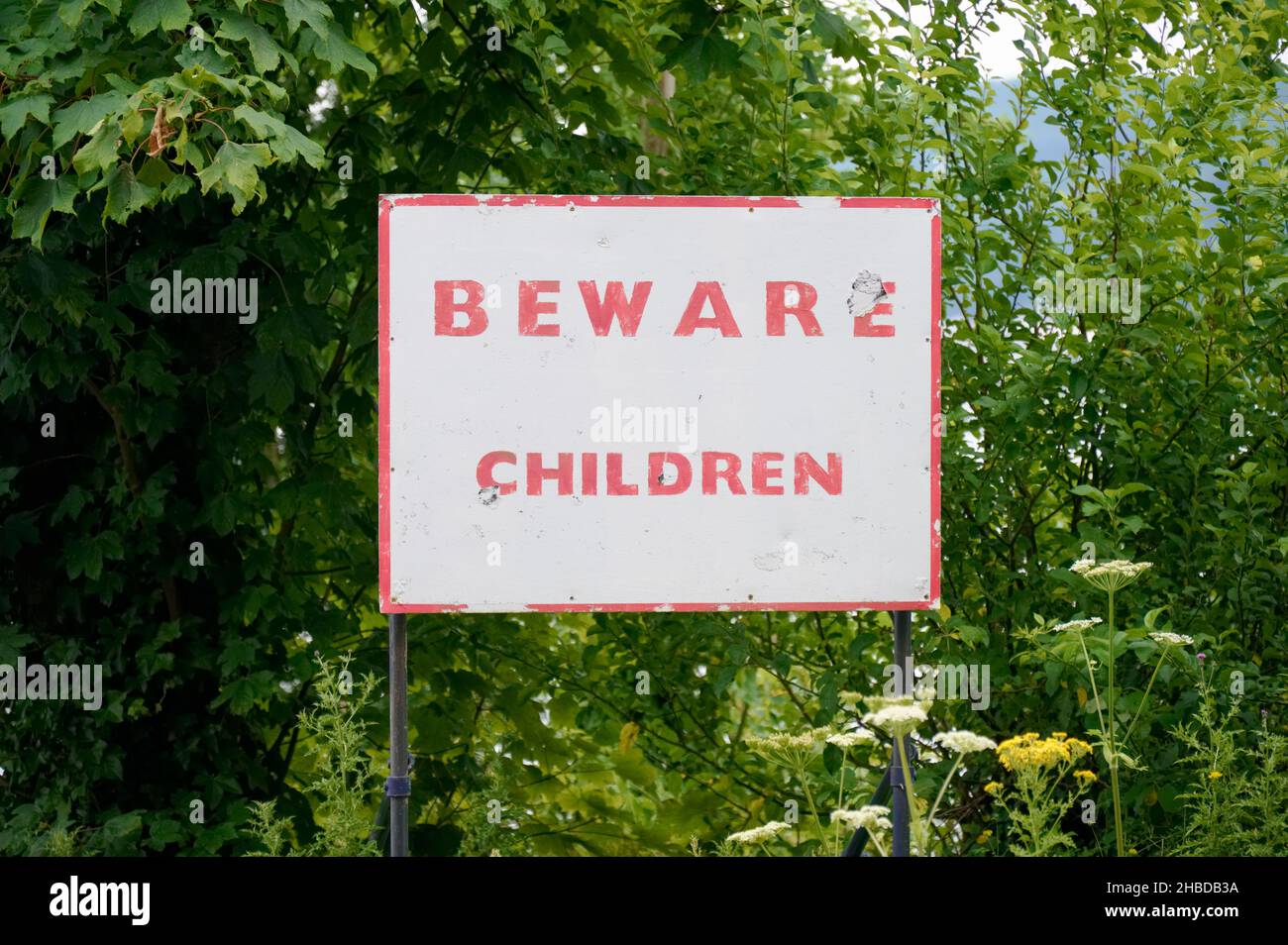 Beware children safety sign on road for drivers Stock Photo - Alamy