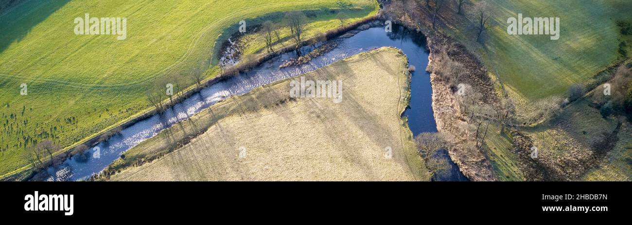 Aerial view of river and empty green meadow field Stock Photo - Alamy