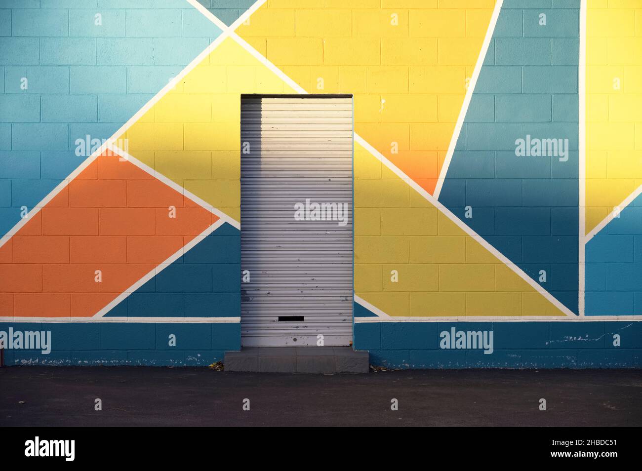 Bright colours on wall painting on shop front entrance Stock Photo - Alamy