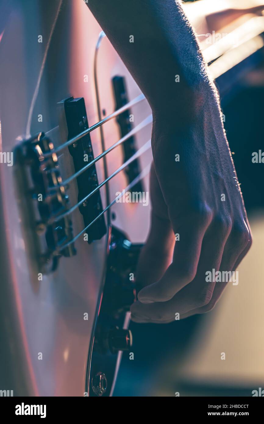 Close-up of a man playing the bass guitar Stock Photo - Alamy
