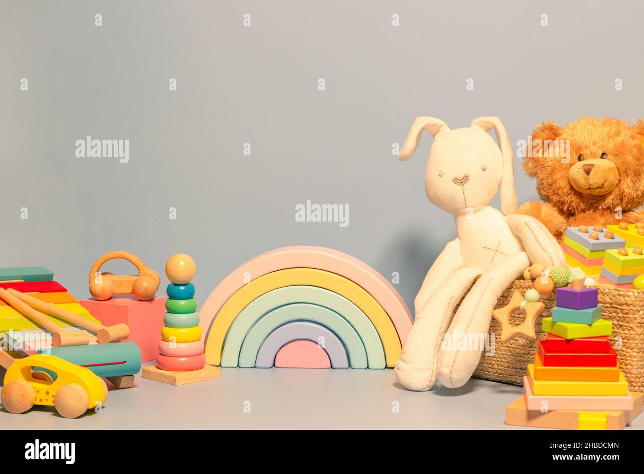 Toys background. Toy box with teddy bear, bunny and wood rattle ...