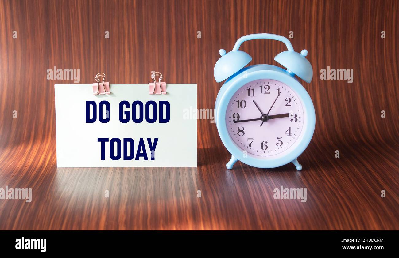 DO GOOD TODAY written on a notepad and a wooden background, next to a ...