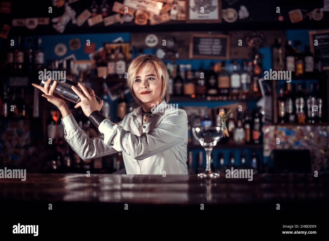 Pretty girl tapster surprises with its skill bar visitors at the night club Stock Photo - Alamy