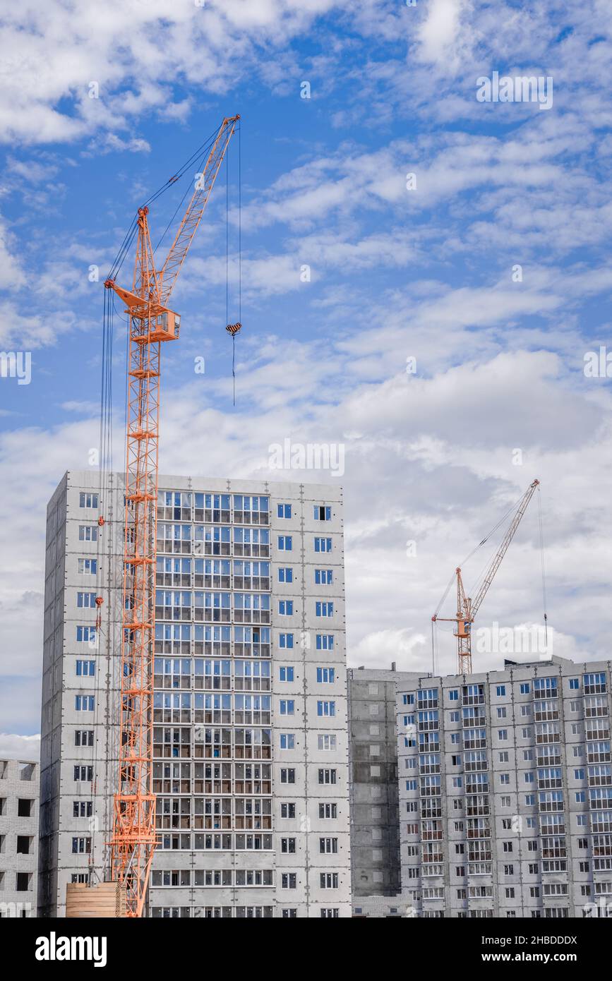 Hoisting crane and building of houses Stock Photo - Alamy