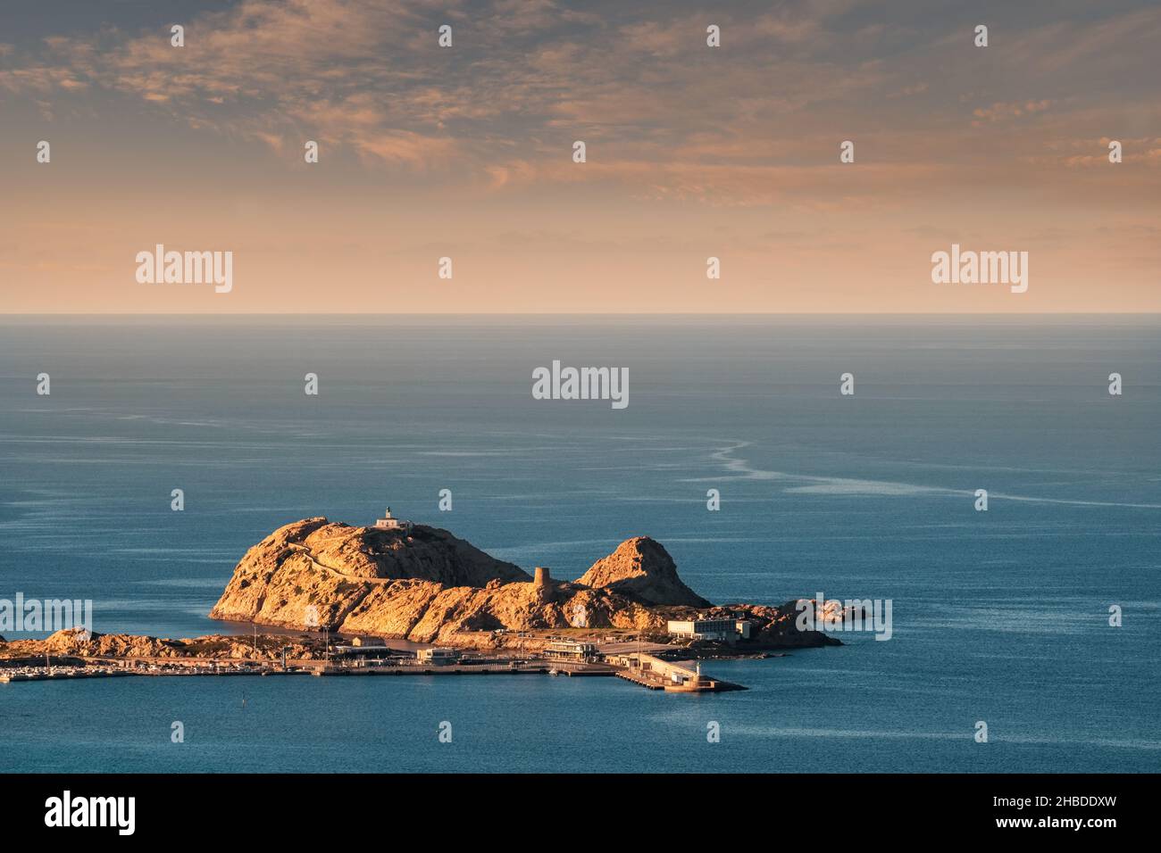 The red rock, La Pietra, with lighthouse and Genoese tower at Ile ...