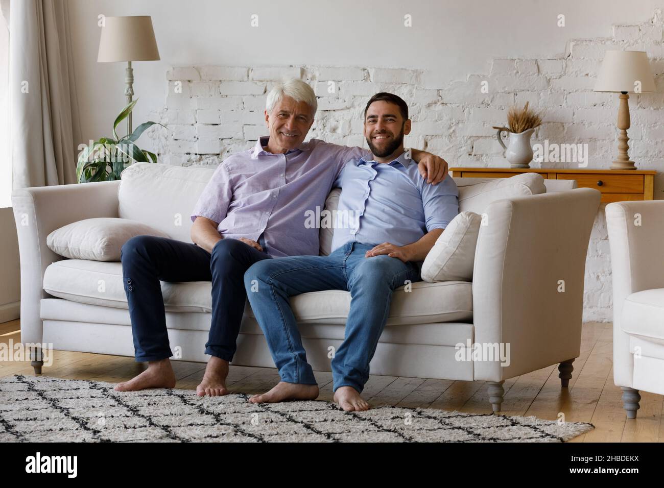 Happy two generations family posing at home Stock Photo - Alamy