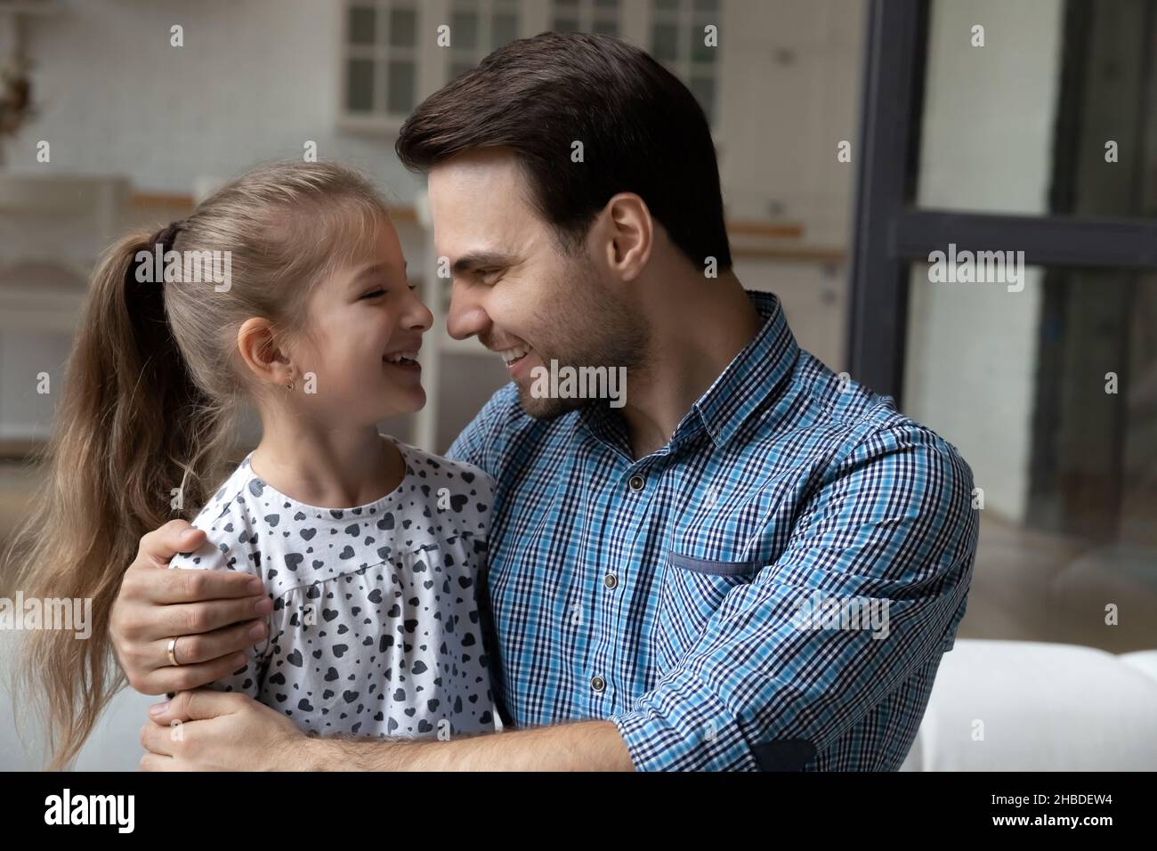 Close up loving smiling father hugging little daughter at home Stock ...