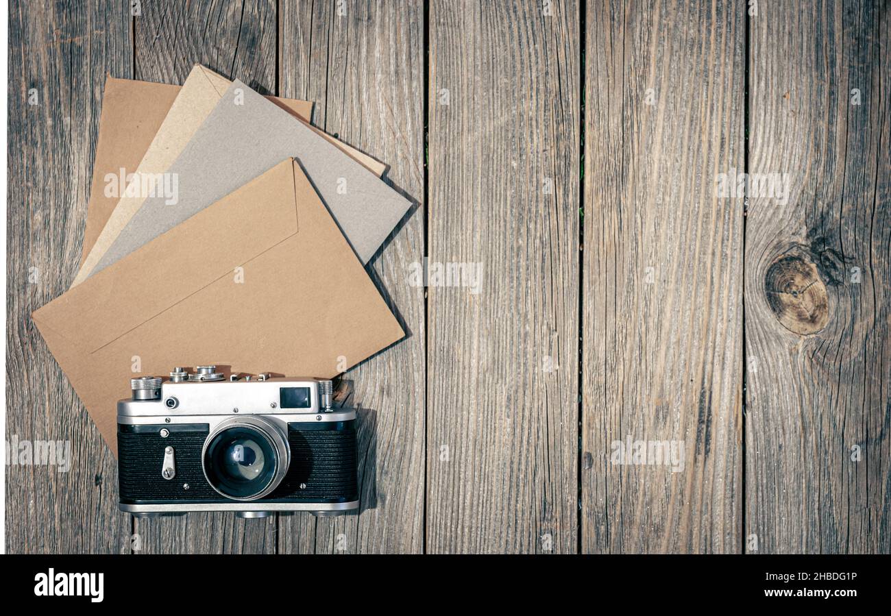 Vintage retro camera and envelopes with letters on wooden background ...