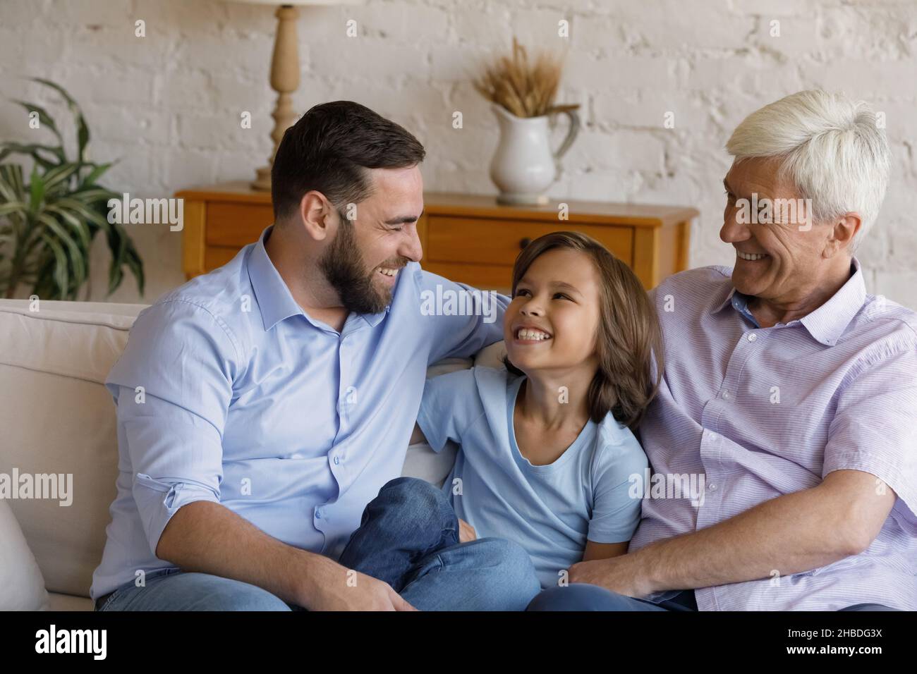 Happy male family enjoying communicating at home Stock Photo - Alamy