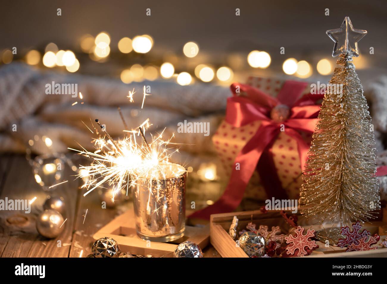 Cozy Christmas background with glowing sparklers and decor details ...