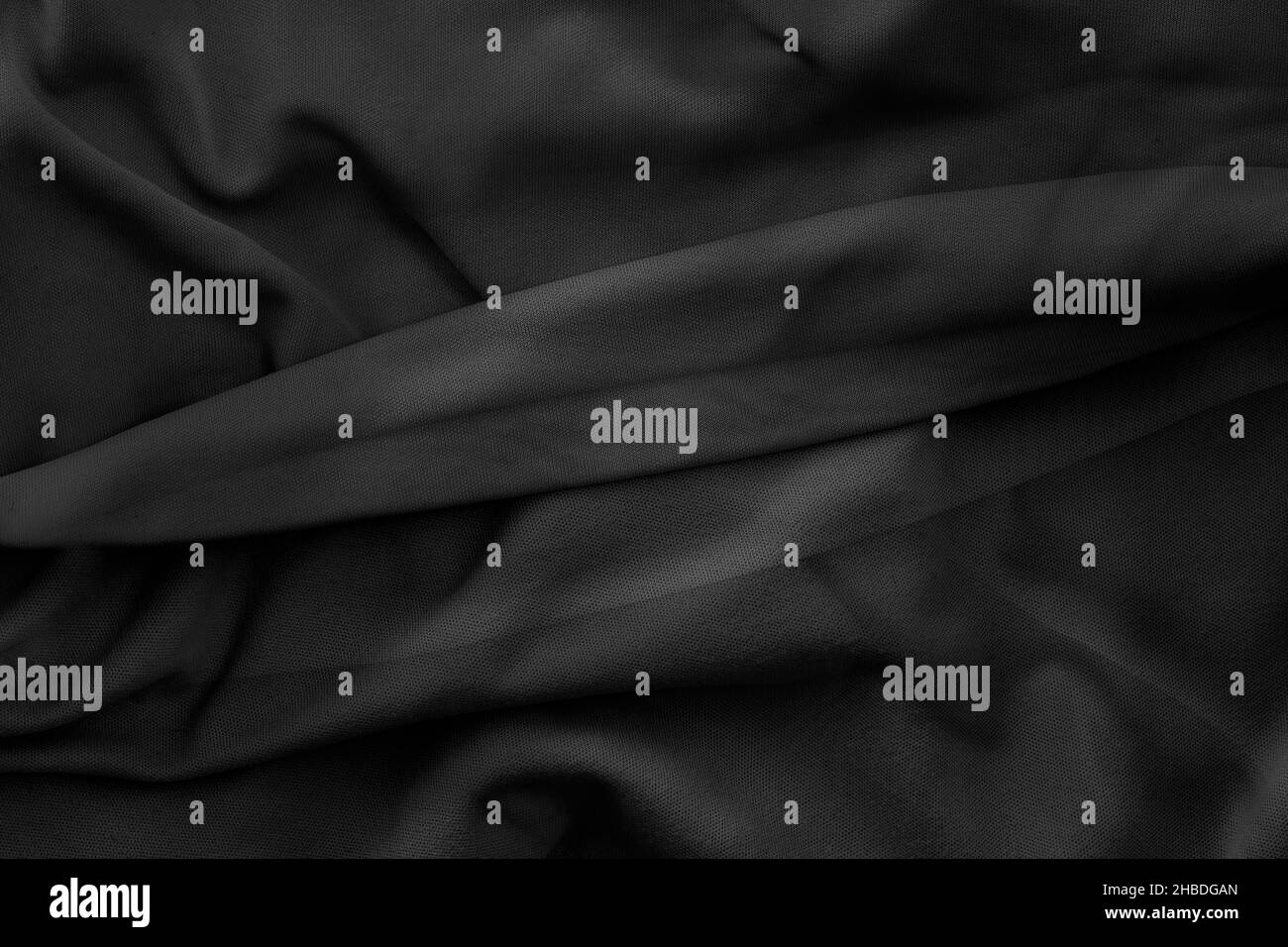 Monochromatic view of folded silk fabric with rough texture for ...