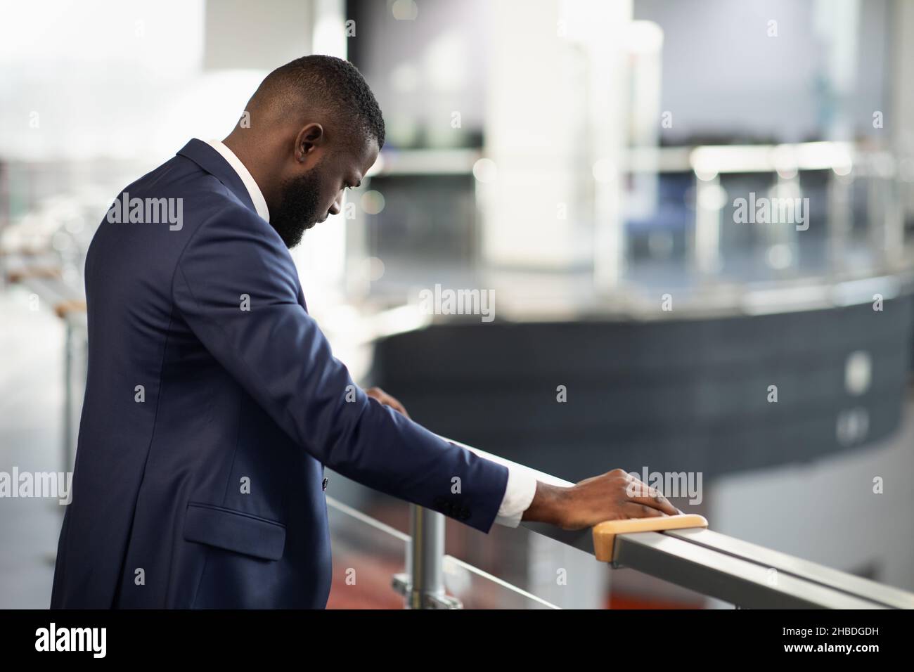 Stressed african american entrepreneur standing by railing Stock Photo ...
