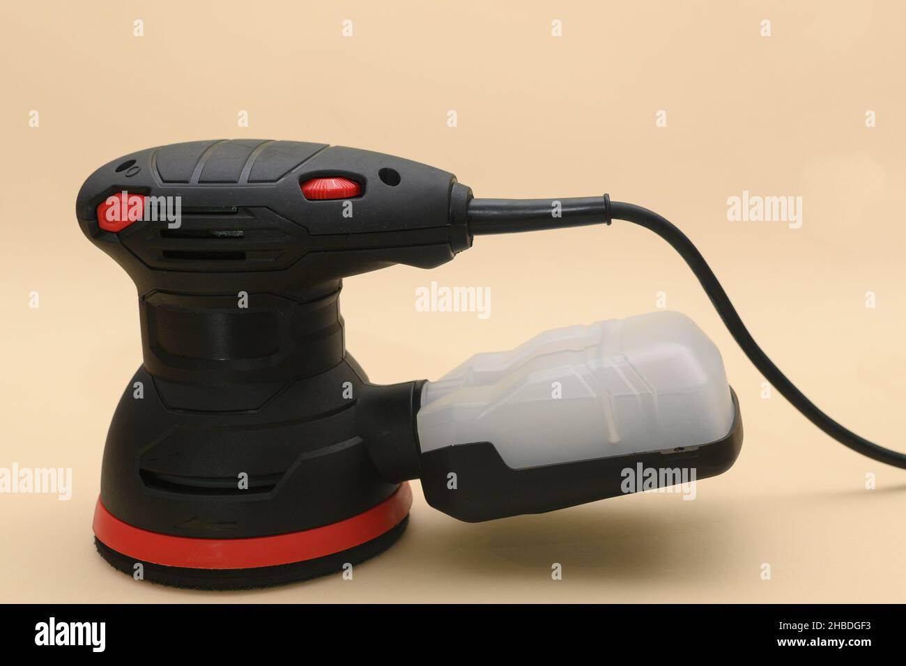 Eccentric orbital grinding machine close-up. beige background Stock ...