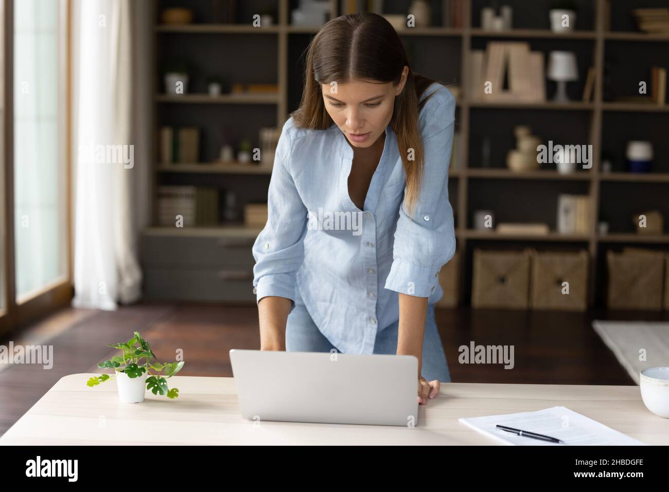 Happy beautiful young woman working on computer Stock Photo - Alamy