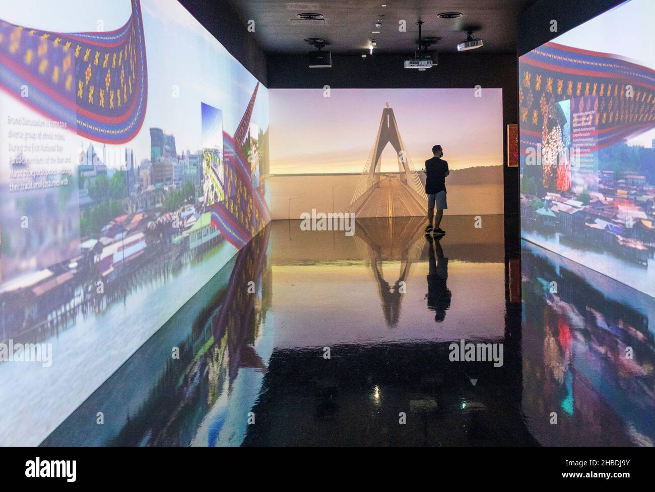 Shot of a man inspecting projections on the wall Stock Photo - Alamy