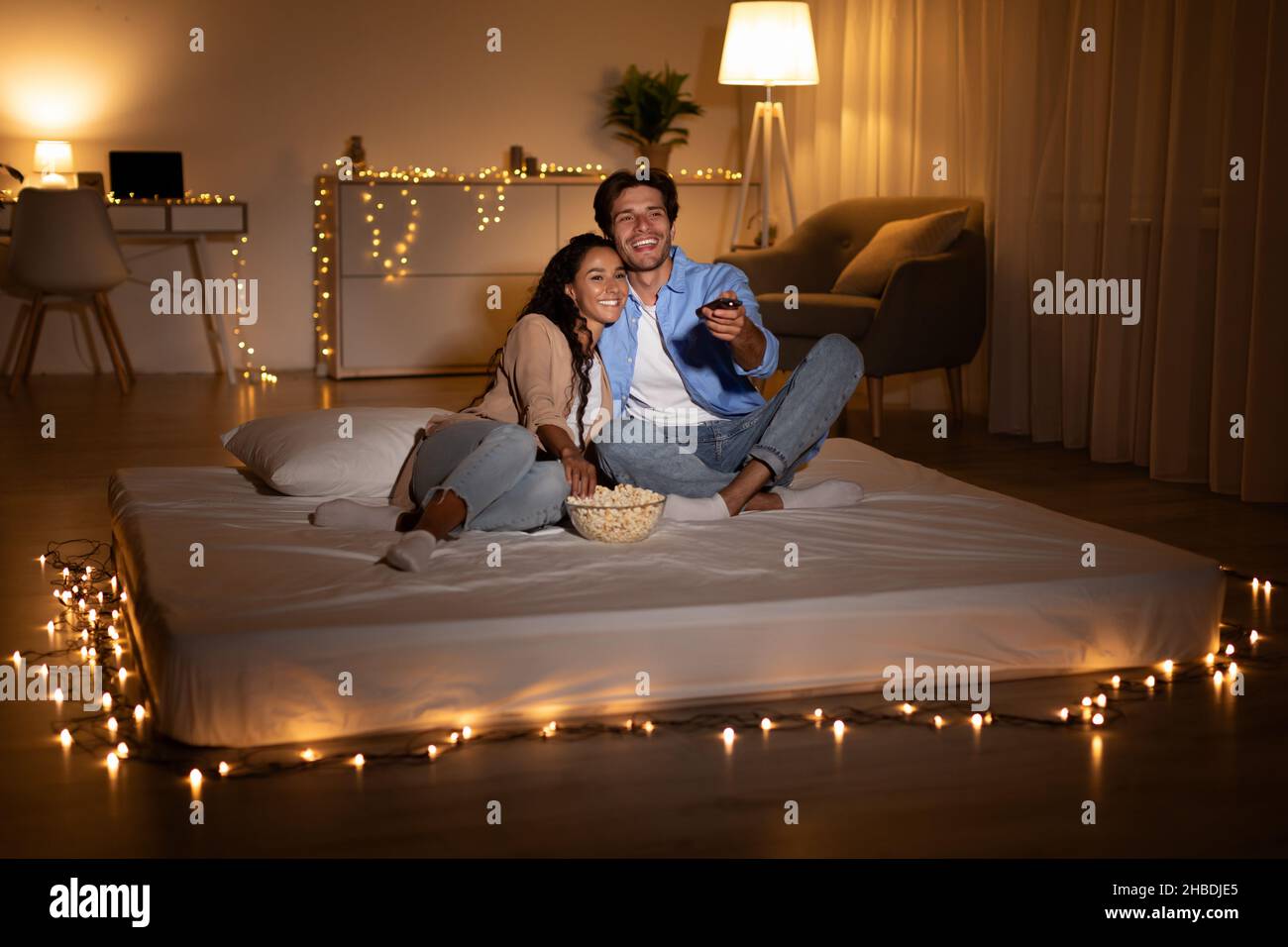 Couple Having Fun Watching Movie On TV At Home Stock Photo - Alamy