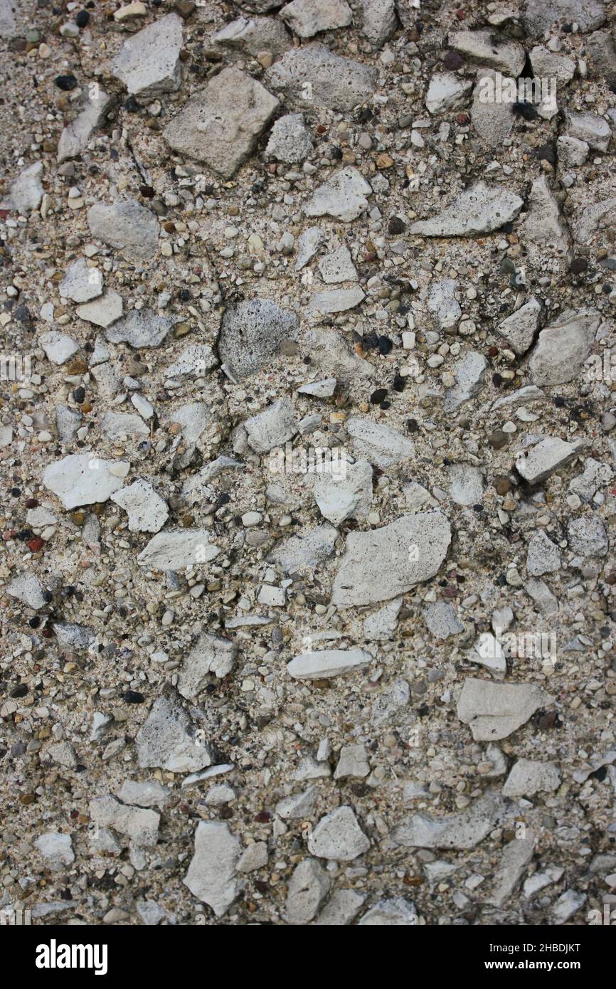 Full frame of heavily worn and weathered concrete showing the gravel ...