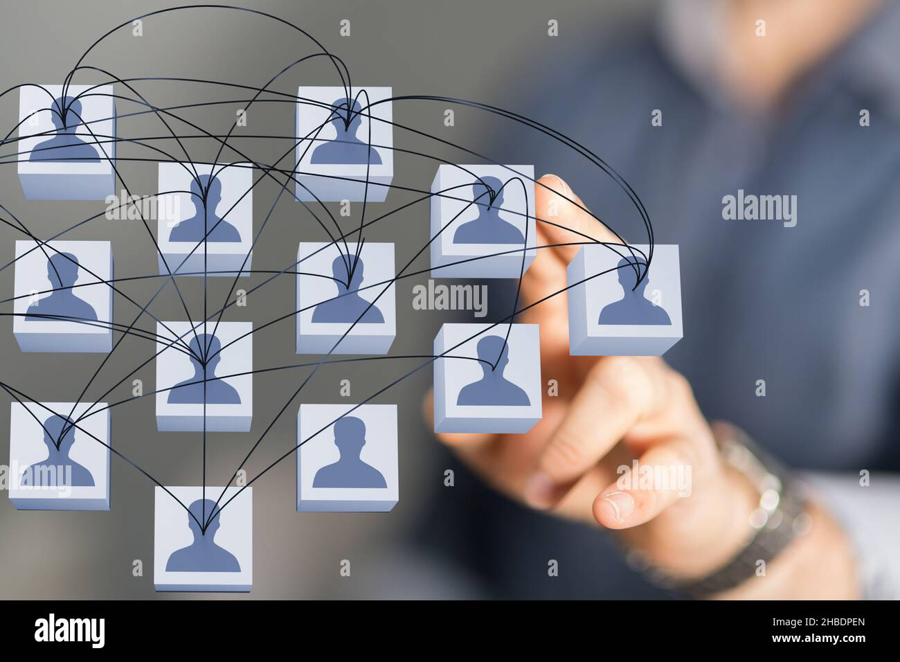 A person touching 3D rendering of human figure icons connected with ...