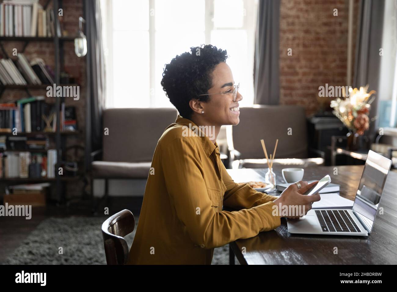 Distracted from computer work happy African American businesswoman ...