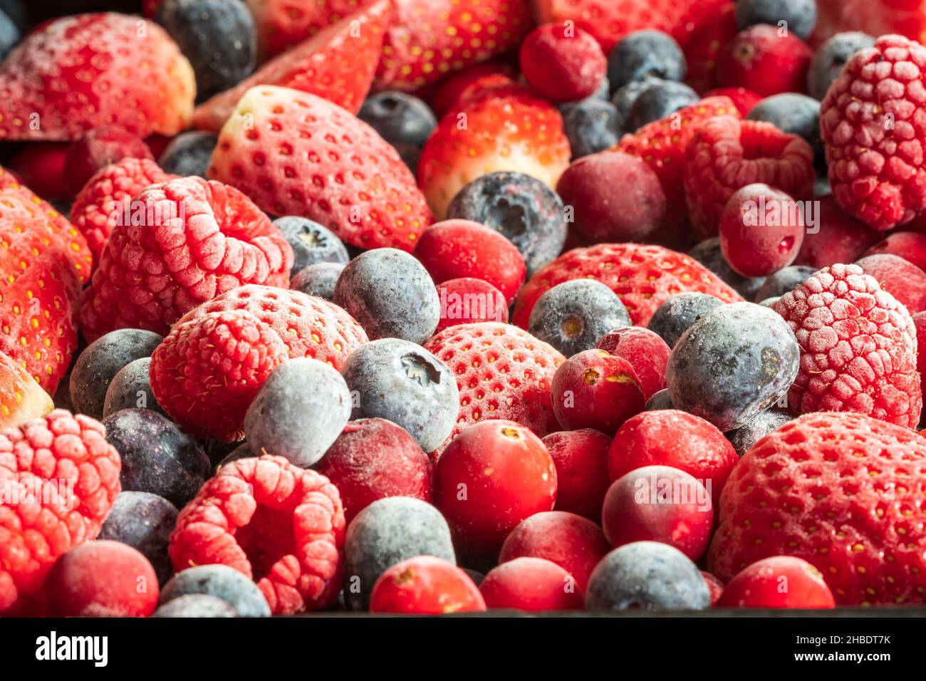 frozen mix strawberries blueberries raspberries and cranberries closeup ...