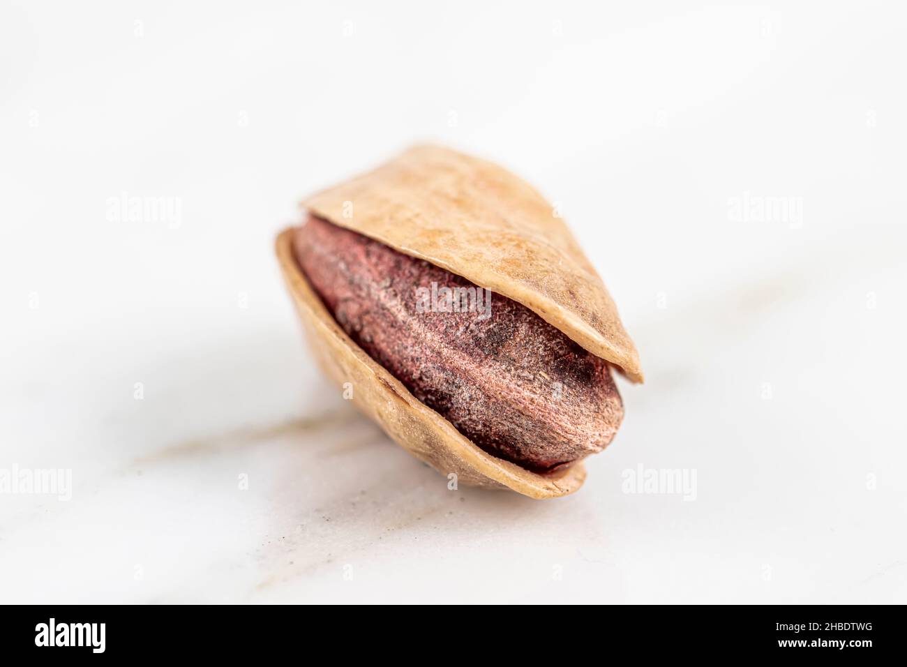 Pile of pistachios in the peel close-up. Pistachio isolated on marble ...