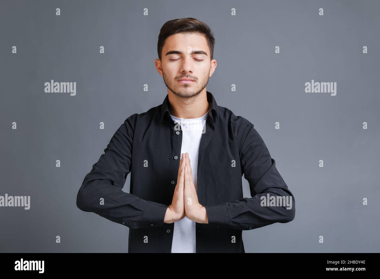 Man keeping hands namaste gesture and meditating Stock Photo - Alamy