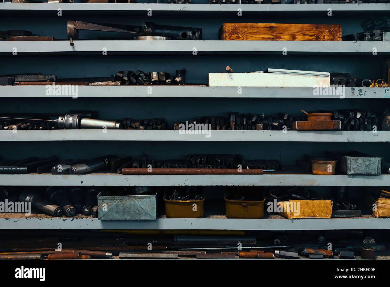Rack with shelves in lathe shop in factory. On shelves are parts and ...