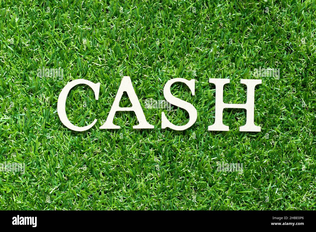 Alphabet letter in word cash on green grass background Stock Photo - Alamy