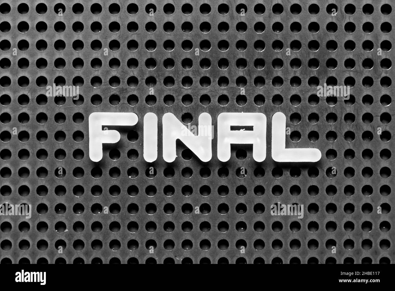 White alphabet letter in word final on black pegboard background Stock ...