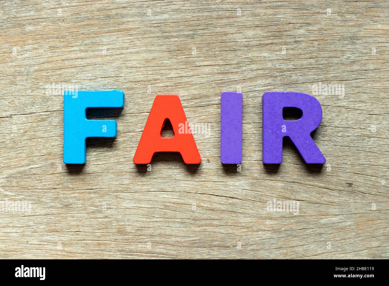 Color alphabet letter in word fair on wood background Stock Photo - Alamy
