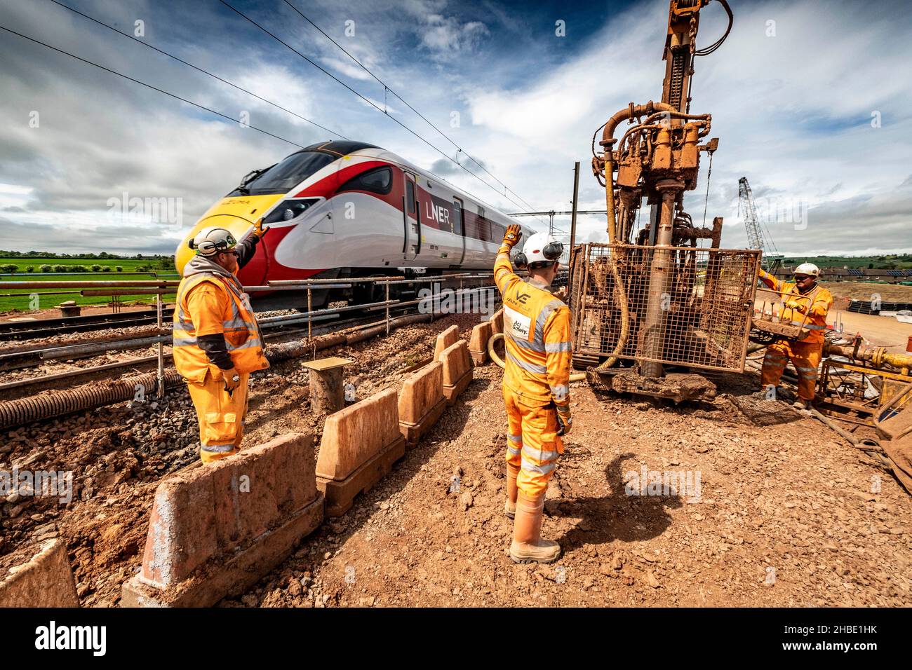 Railway workers building new railway and knocking down bridges Stock ...